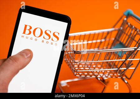 In this photo illustration, a Hugo Boss company logo is seen displayed ...