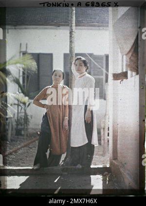 Tonkin, Indochina two wealthy young girls sitting in a garden, in front ...