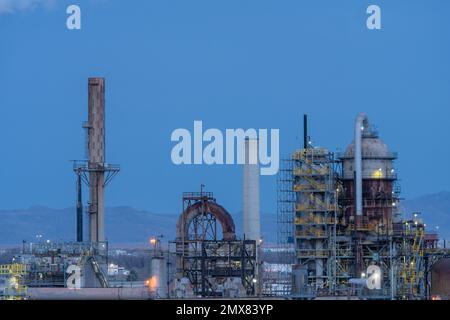 An oil refinery lit up in pre-dawn twilight near Salt Lake City, Utah ...