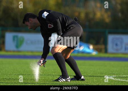 FA Wales referee marking a free kick line with water spray Stock Photo ...
