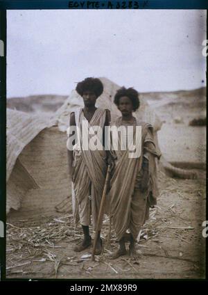 ASSOUAN, Egypt, Africa two bishari men posing in front of a house ...