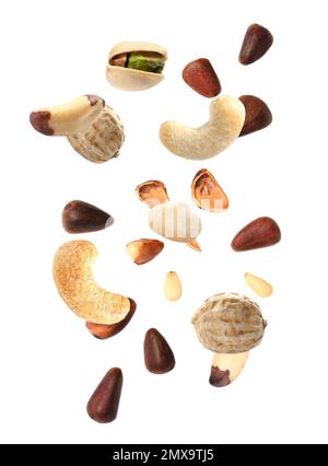 Different nuts falling on white background Stock Photo - Alamy