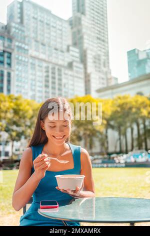 Young woman eating healthy oatmeal on pink background Stock Photo - Alamy