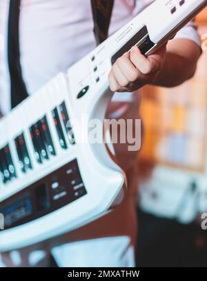 Concert view of a keytar synthesizer player with vocalist and musical ...