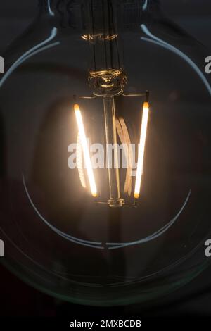 Shining light bulb lighting inside a glass bulb Stock Photo - Alamy