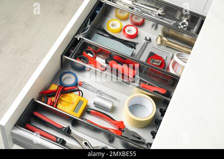 Set of instruments in open desk drawer indoors Stock Photo - Alamy