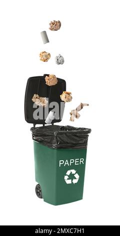 Different paper garbage falling into trash bin. Waste management and ...