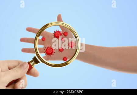 Woman detecting bacteria with magnifying glass on blue background ...