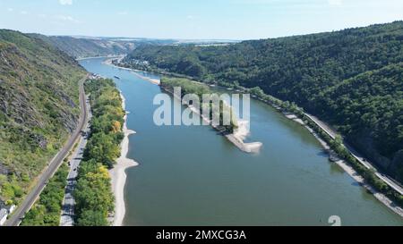 An aerial view of a river stream splitting into two by a small island ...