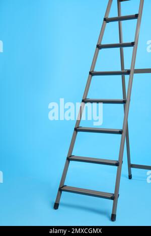 Blue stepladder on light background Stock Photo - Alamy