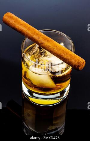 Cigar and whisky, symbol of addiction and pleasure Stock Photo - Alamy