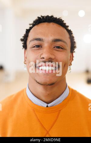 Vertical image of biracial male hip hop dancer dancing in smoked ...