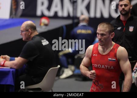 ZAGREB, CROATIA – FEBRUARY 03: Bozo Starcevic of Croatia (red) competes ...