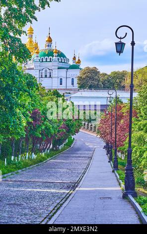 A beautiful monastery in the background of an alley with street lamps ...