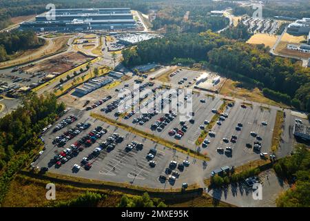 Many associate cars parked on big parking lot in front of industrial ...