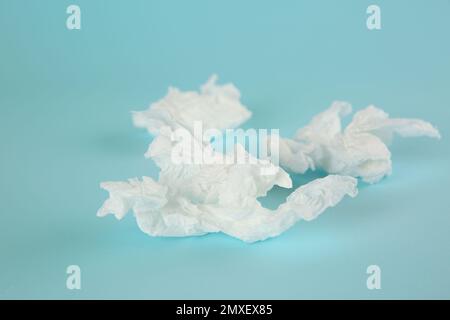 Used paper tissues on light blue background, closeup Stock Photo - Alamy