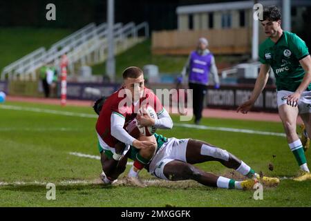 Ike Anagu #14 of Ireland U20's tackless Cameron Winnett #15 of Wales ...