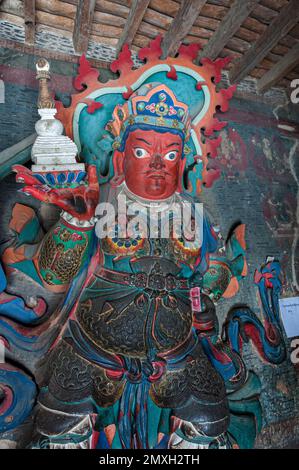 Brightly coloured statues of Tibetan deities inside the Buddhist Kumbum ...