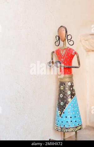 A vertical shot of metal stick figure dolls on the steps of a stair ...
