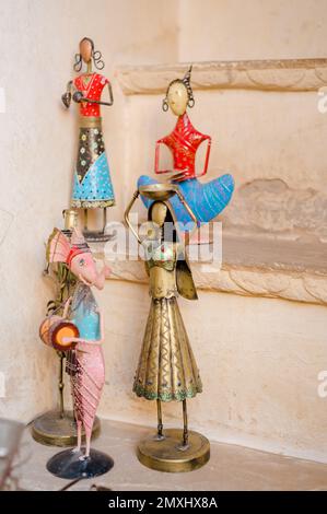 A vertical shot of metal stick figure dolls on the steps of a stair ...
