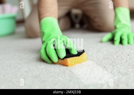 Man removing dirt from carpet at home, closeup. Cleaning service Stock ...