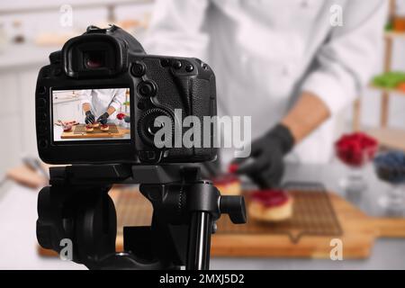 Food photography. Shooting of chef decorating dessert, focus on camera ...