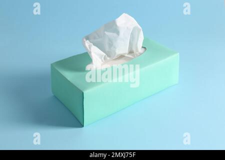 Box of paper tissues on light blue background. Space for text Stock ...