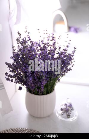 Beautiful lavender flowers on countertop near sink in kitchen Stock ...