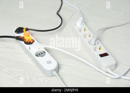 Inflamed plug in power board - result of electrical short circuit Stock ...