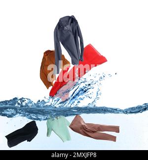Different clothes falling into water against white background Stock ...