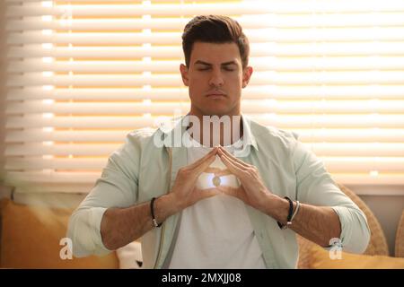 Man during self-healing session in therapy room Stock Photo - Alamy