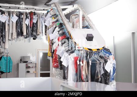 Modern dry-cleaner's interior with counter and garment conveyor Stock ...