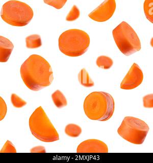 Fresh carrot slices falling on white background Stock Photo - Alamy