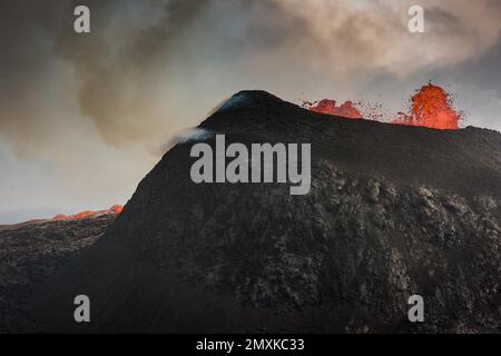 Lava fountain spraying from crater, cooled lava flows, active table ...