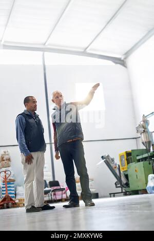 Factory worker doing paperwork in a factory warehouse Stock Photo - Alamy
