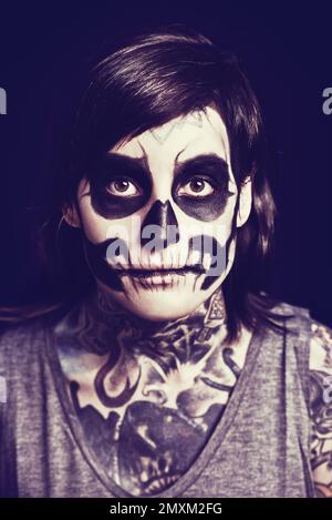 Facing death. A woman with a traditional calaveras death mask painted ...