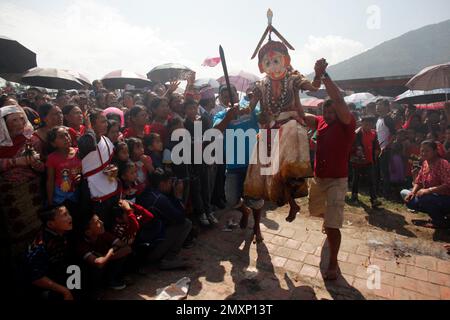 A Nepalese mask dancer dance in a traditional attire during Gai Jatra ...