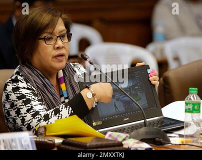 Former Filipino militiaman Edgar Matobato, center, walks under tight ...