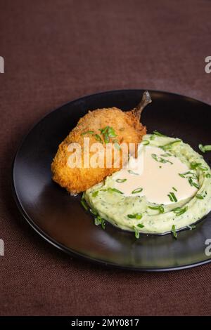 Two golden brown breaded pork chops served on rustic grey plate. Fresh ...