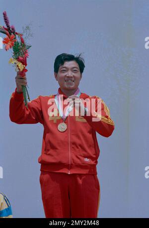 Wu Haifeng of China receives his gold medal in the men's free pistol competition in Los Angeles ...