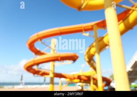 Different colorful slides in water park, blurred view Stock Photo - Alamy