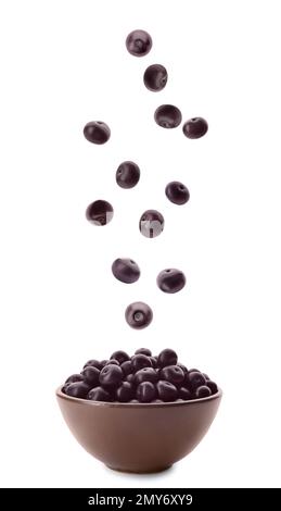 Fresh acai berries falling on white background Stock Photo - Alamy