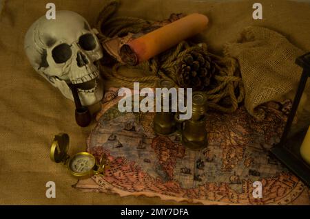 Adventure exploration scroll next to skull of a skull with smoking pipe ...