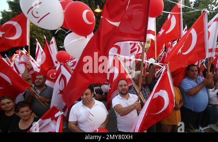 Turkish Cypriot demonstrators wave Turkish and Turkish Cypriot flags ...