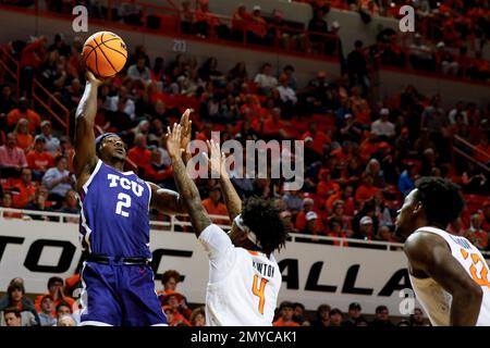 TCU's Emanuel Miller (2) shoots over Oklahoma State's Woody Newton (4 ...