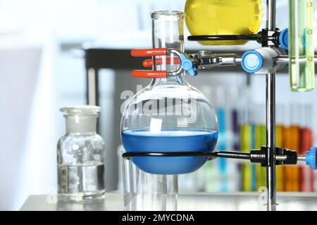 Laboratory clamp stand with glassware, closeup view Stock Photo - Alamy