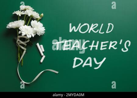 Text World Teacher's Day, chalk and bouquet on greenboard, top view ...