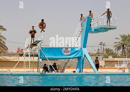 Iraqis swim in a public swimming pool in Baghdad, Iraq, Saturday, Aug ...