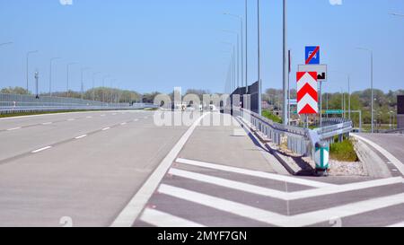 Straight modern concrete motorway with bright road marking ...
