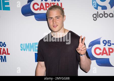 Singer Mike Posner poses for photographers before performing on stage ...